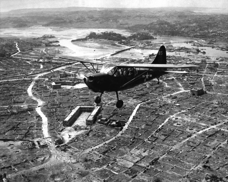 ملف:Stinson OY-1 flies over Naha, Okinawa, circa in May 1945 (532379 ...